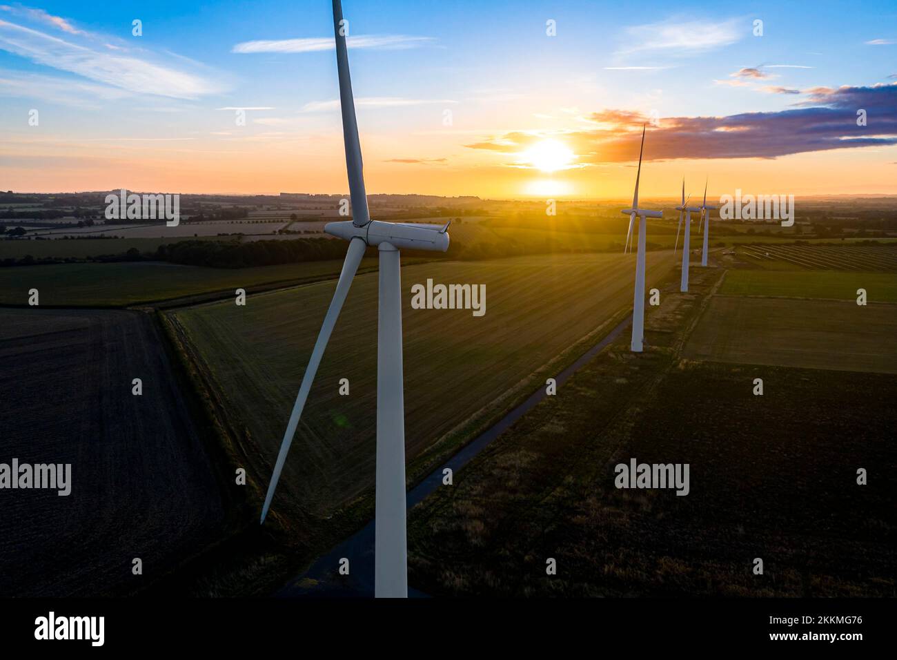 Wind turbines at sunrise Stock Photo - Alamy