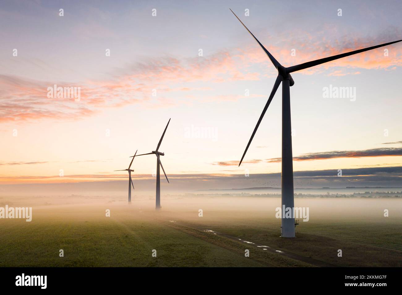 Wind turbines in fog Stock Photo - Alamy
