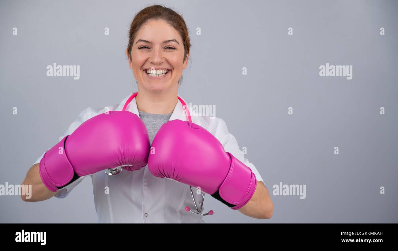 Woman doctor in pink boxing gloves on a white background Stock Photo ...