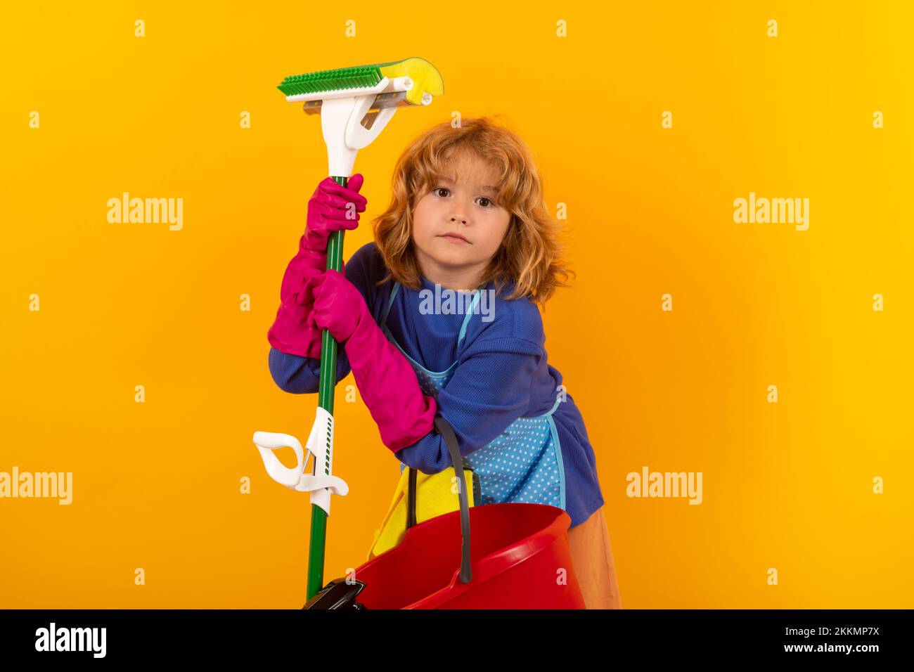 Child cleans at home concept. Kid cleaning with mop to help with ...