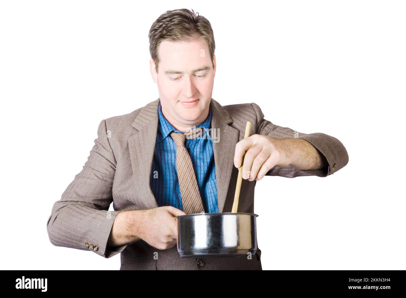 Cooking man wearing business suit stirring food with wooden spoon in ...