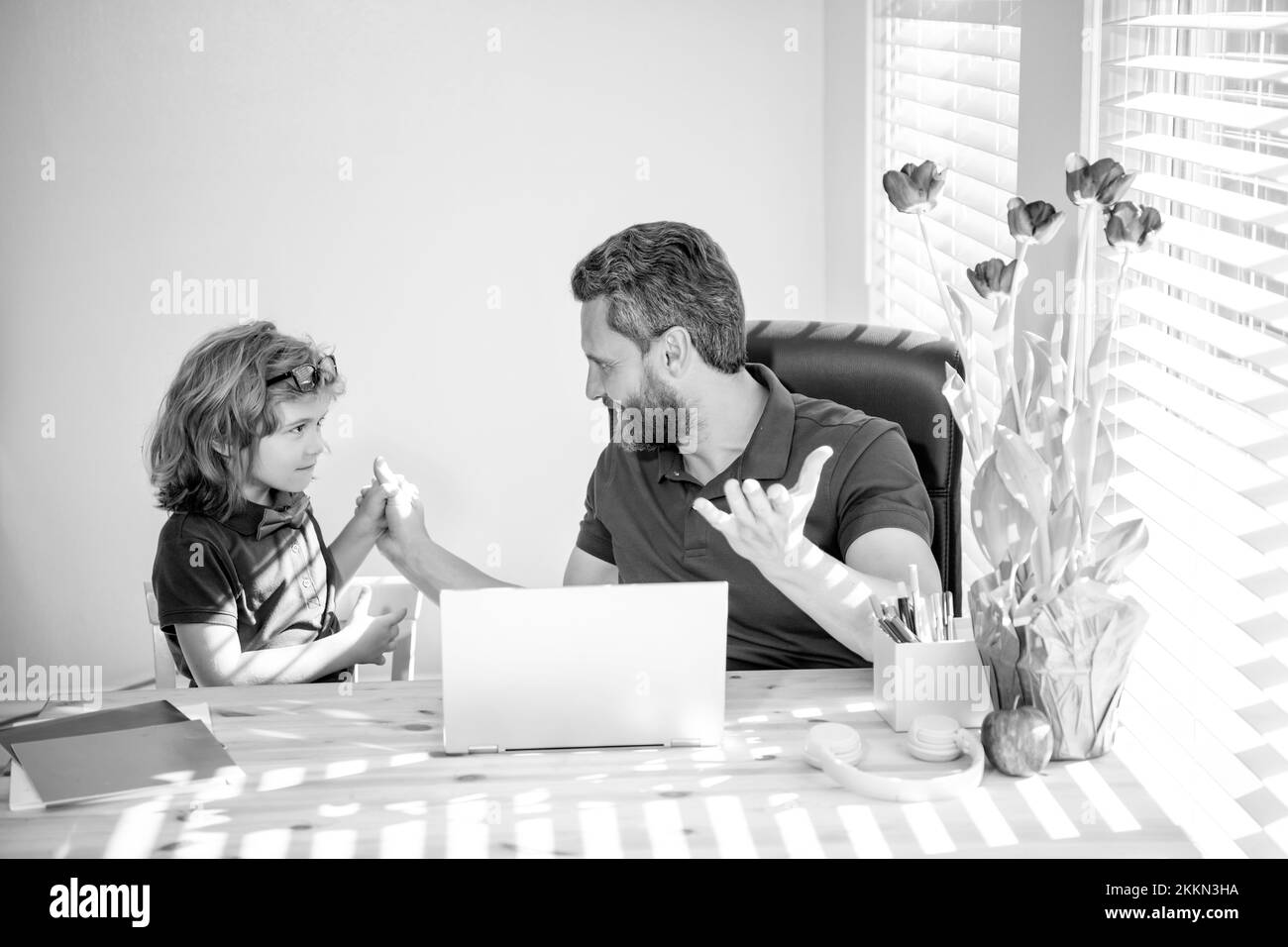 surprised father and son use computer at home. family and parenthood ...