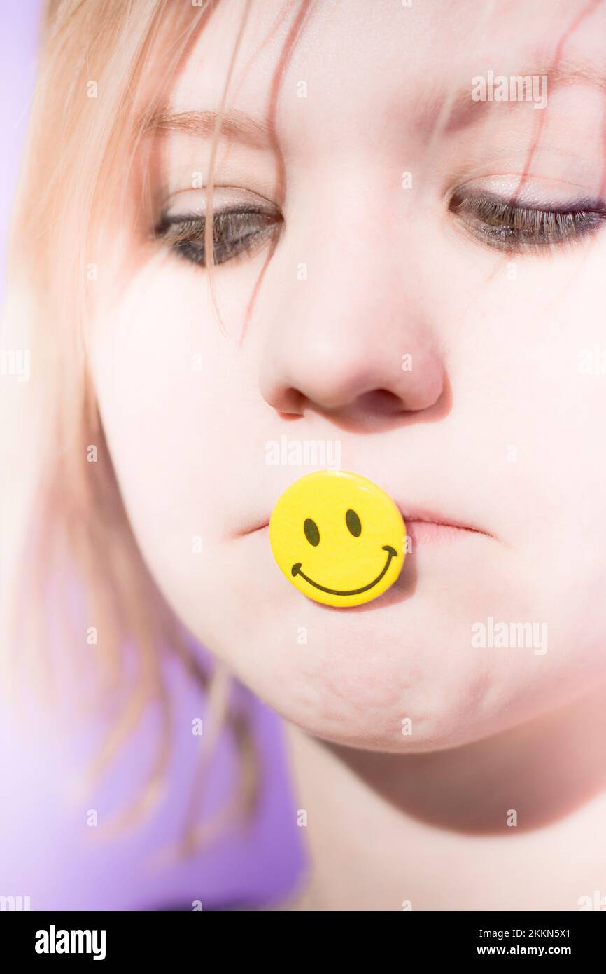 Sad And Depressed Woman With A Smile Badge In Her Mouth Puts On A Happy ...