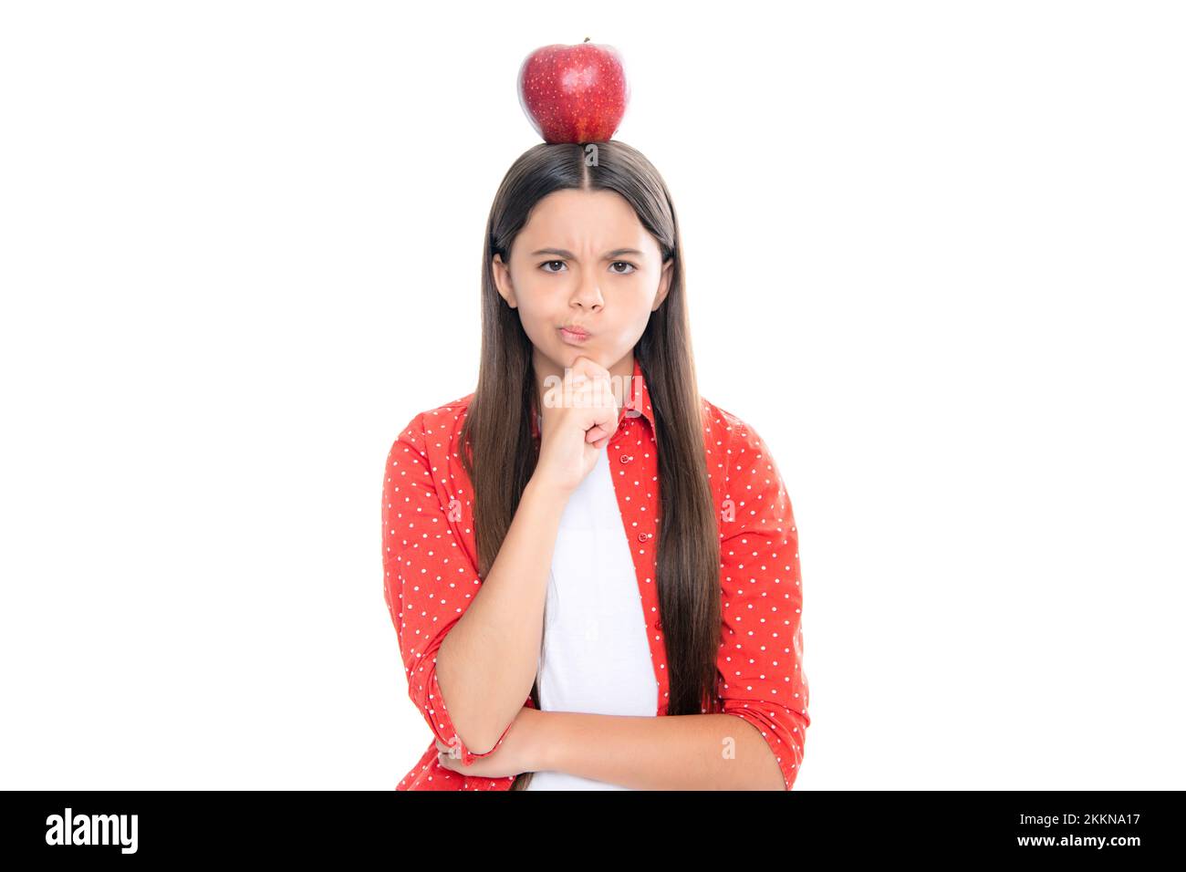 Teenager child girl biting tasty green apple. Thinking pensive clever ...