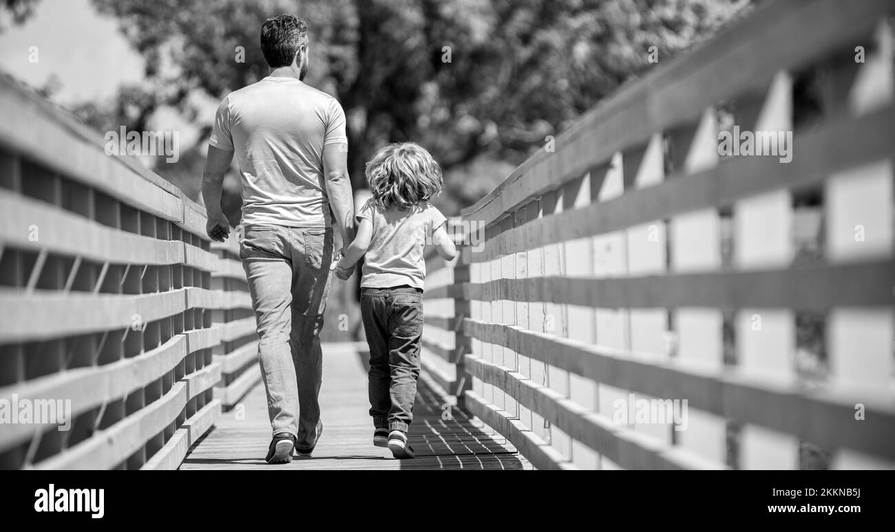 parenting and fatherhood. fathers day. happy father and son walking ...
