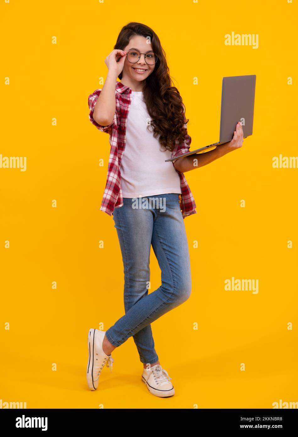 Young girl student hold computer. Funny pupil with laptop isolated on ...