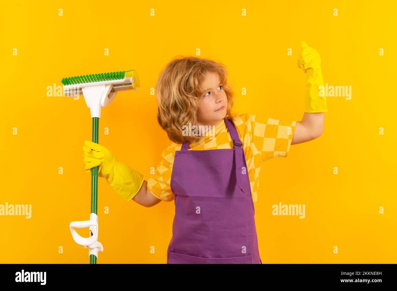 Child cleans at home concept. Kid cleaning with mop to help with ...