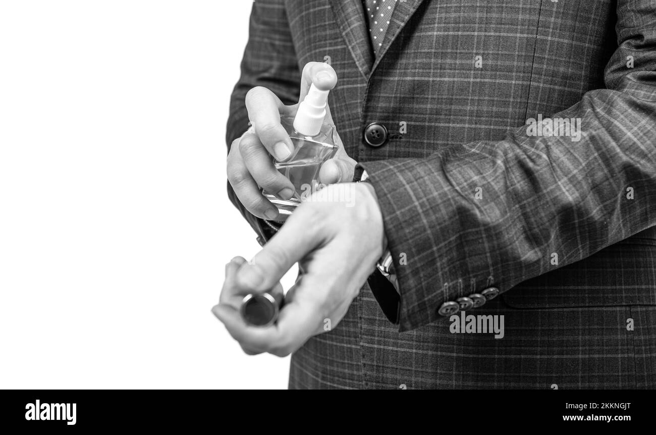 Professional man in business suit cropped view spray perfume to wrist ...