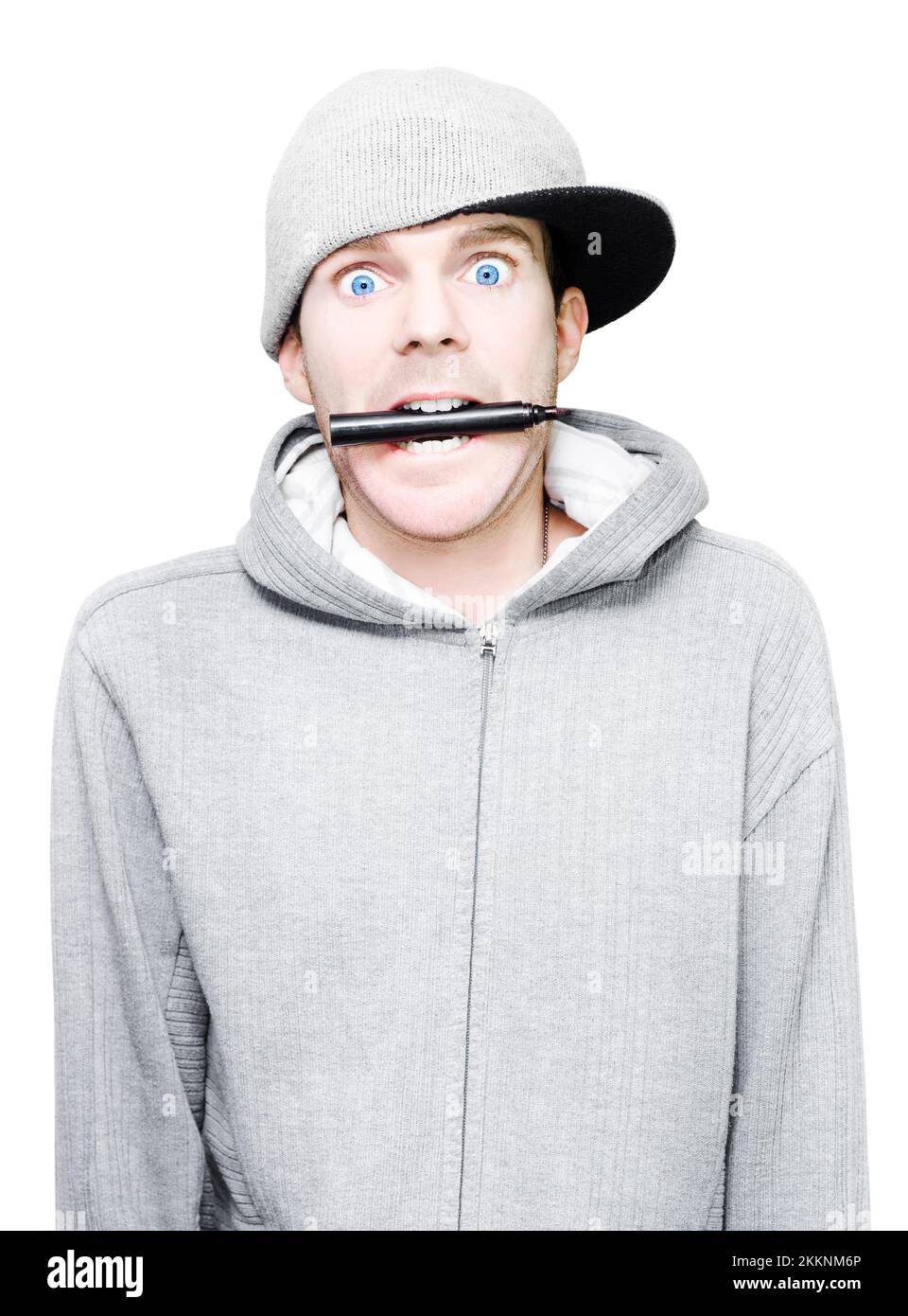 Modern young man standing to attention with a black pen clenched firmly ...