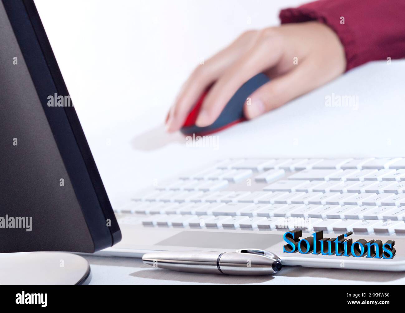 A female secretary in red blouse is working at her modern workstations ...