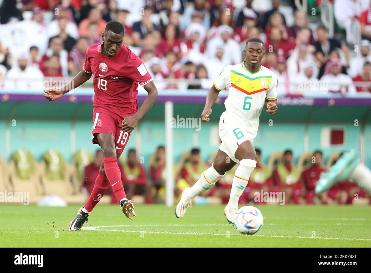Doha, Qatar. 25th Nov, 2022. Almoez Ali of Qatar, Nampalys Mendy of Senegal during the FIFA ...