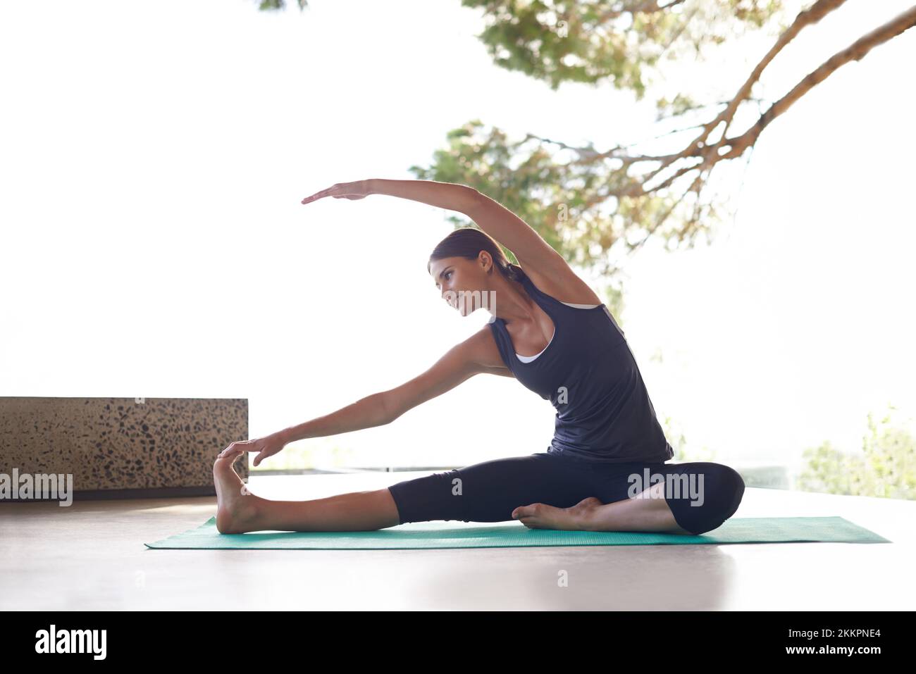 Reaching for her fitness goals. an attractive young woman working out ...