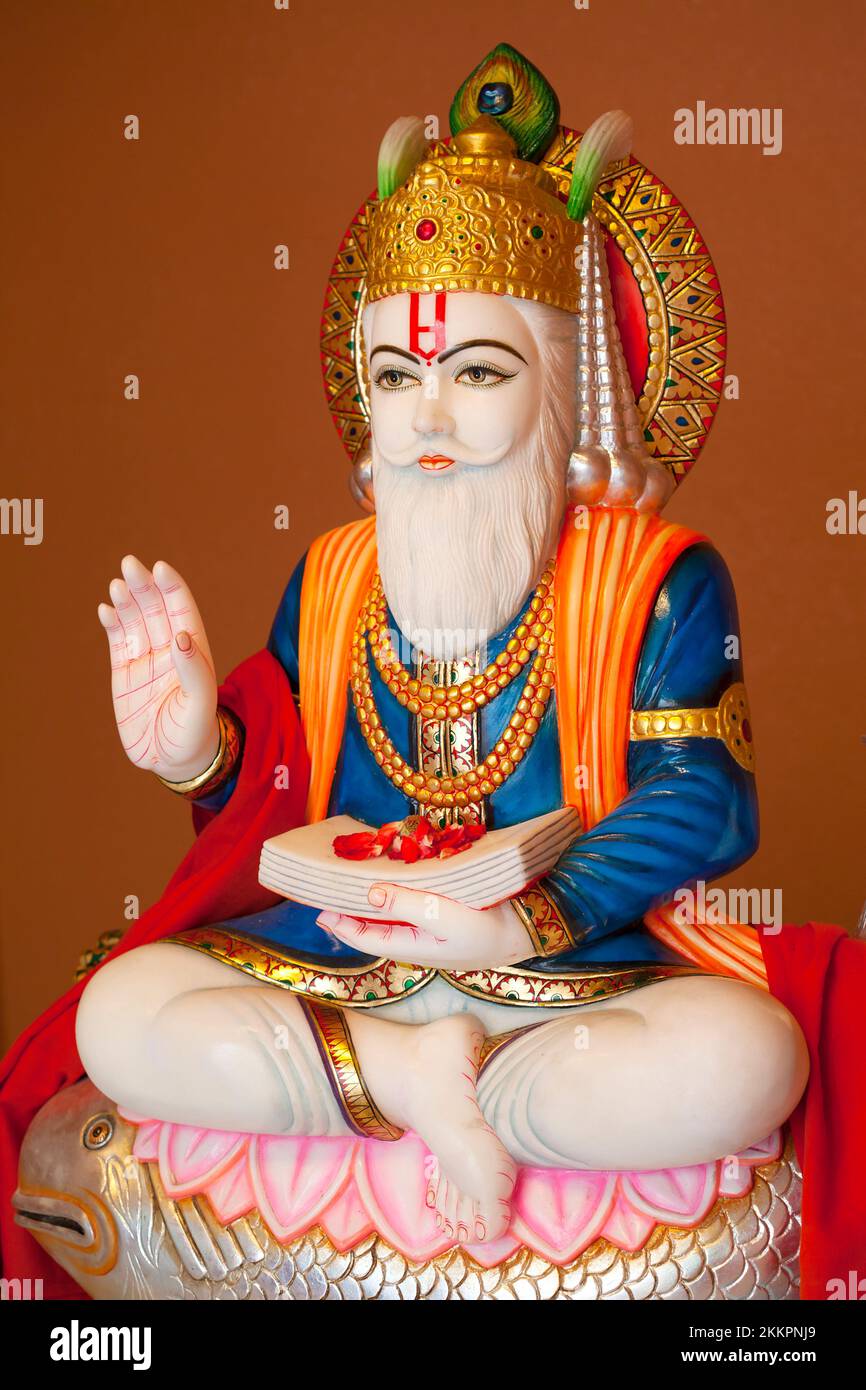 Hindu god Jhulelal sitting cross-legged on a lotus flower that rests on ...
