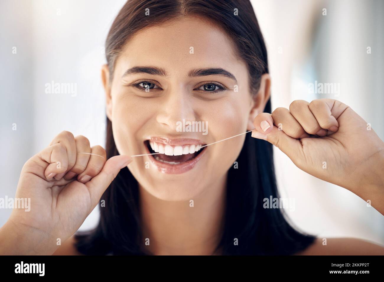 Floss, oral care and dental with healthy teeth and woman cleaning mouth in portrait, gum health ...