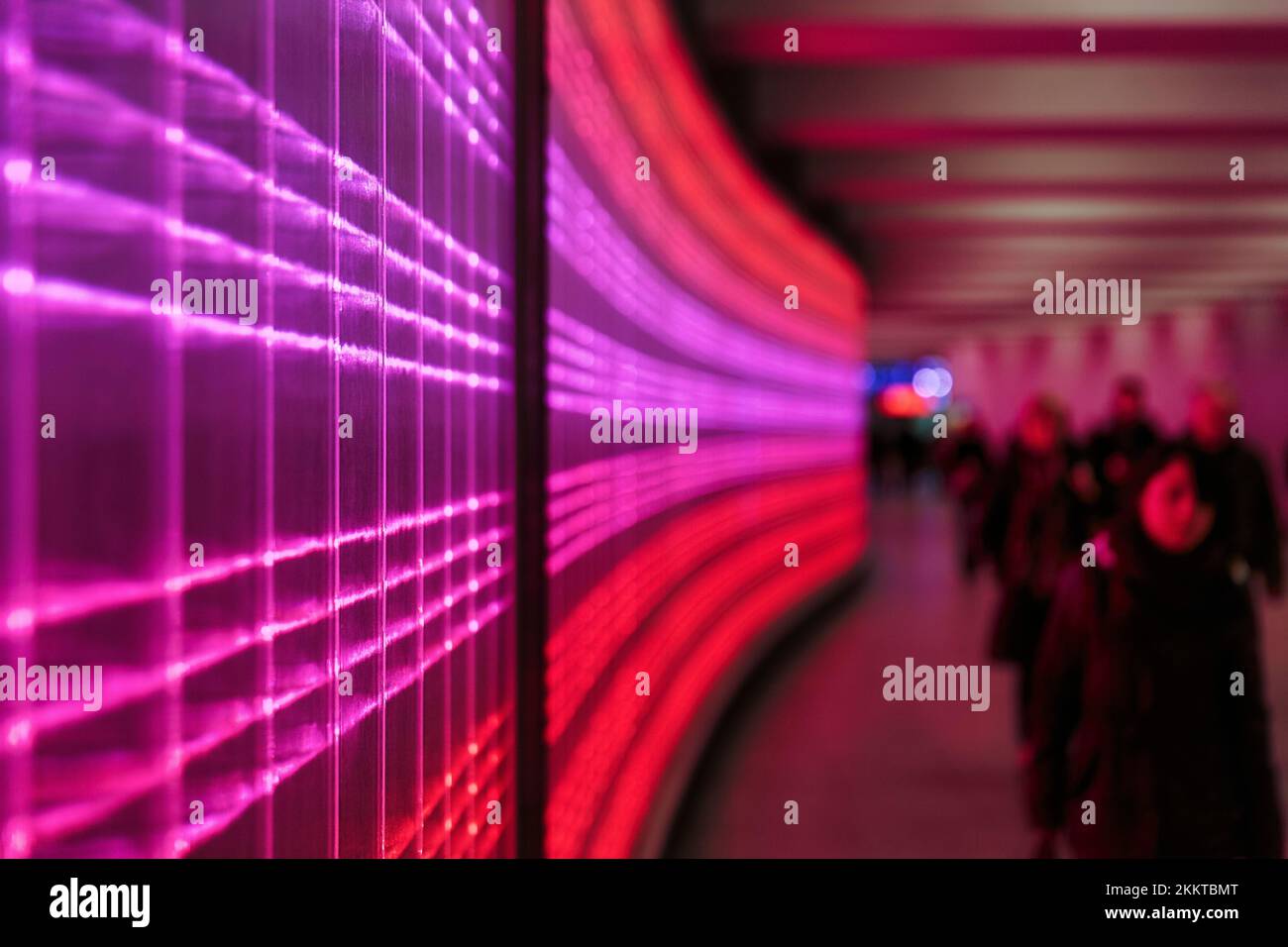 Passers-by in Passerelle underground passage, colourfully illuminated ...