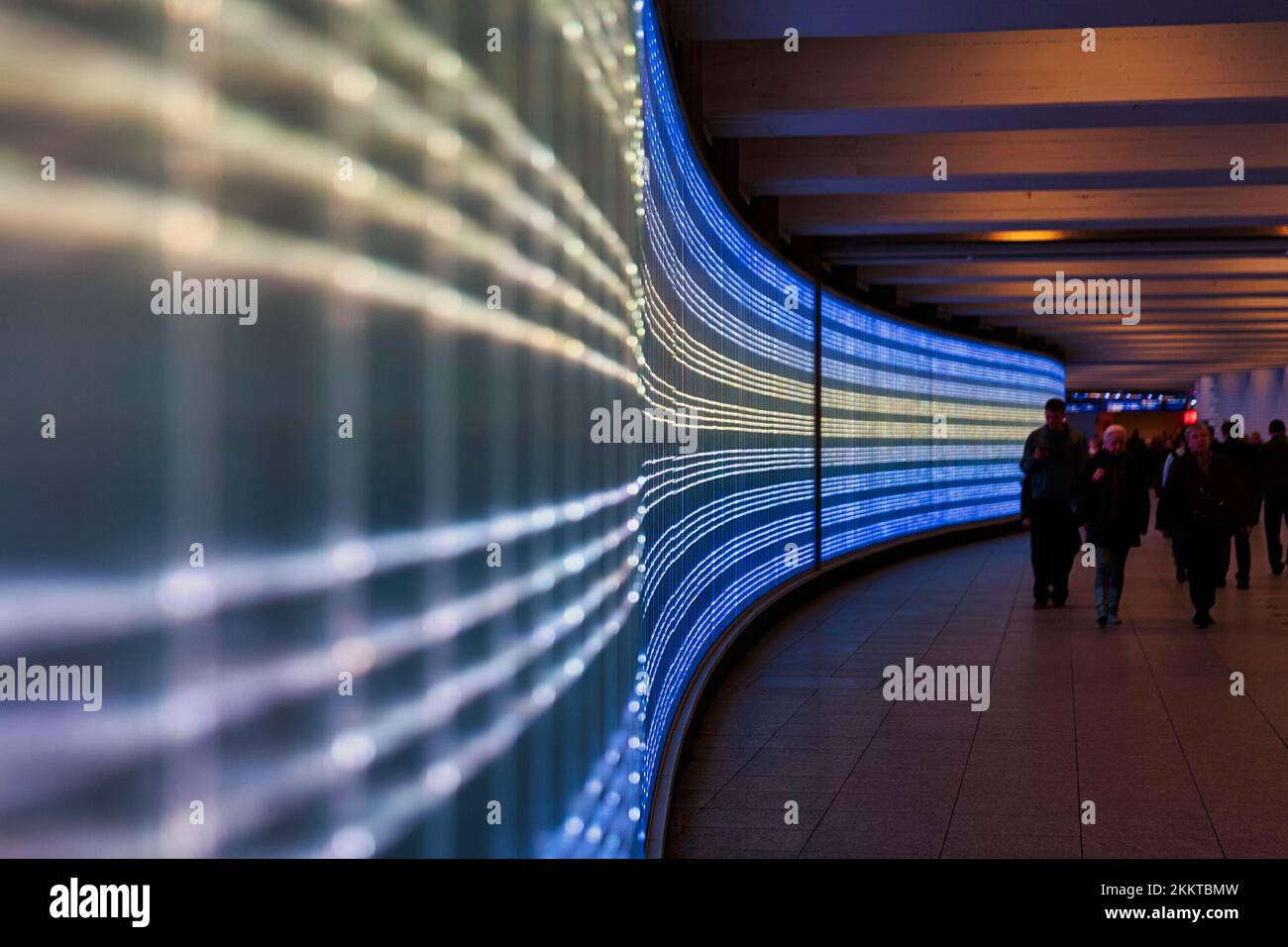 Passers-by in underground passage Passerelle, blue and yellow ...