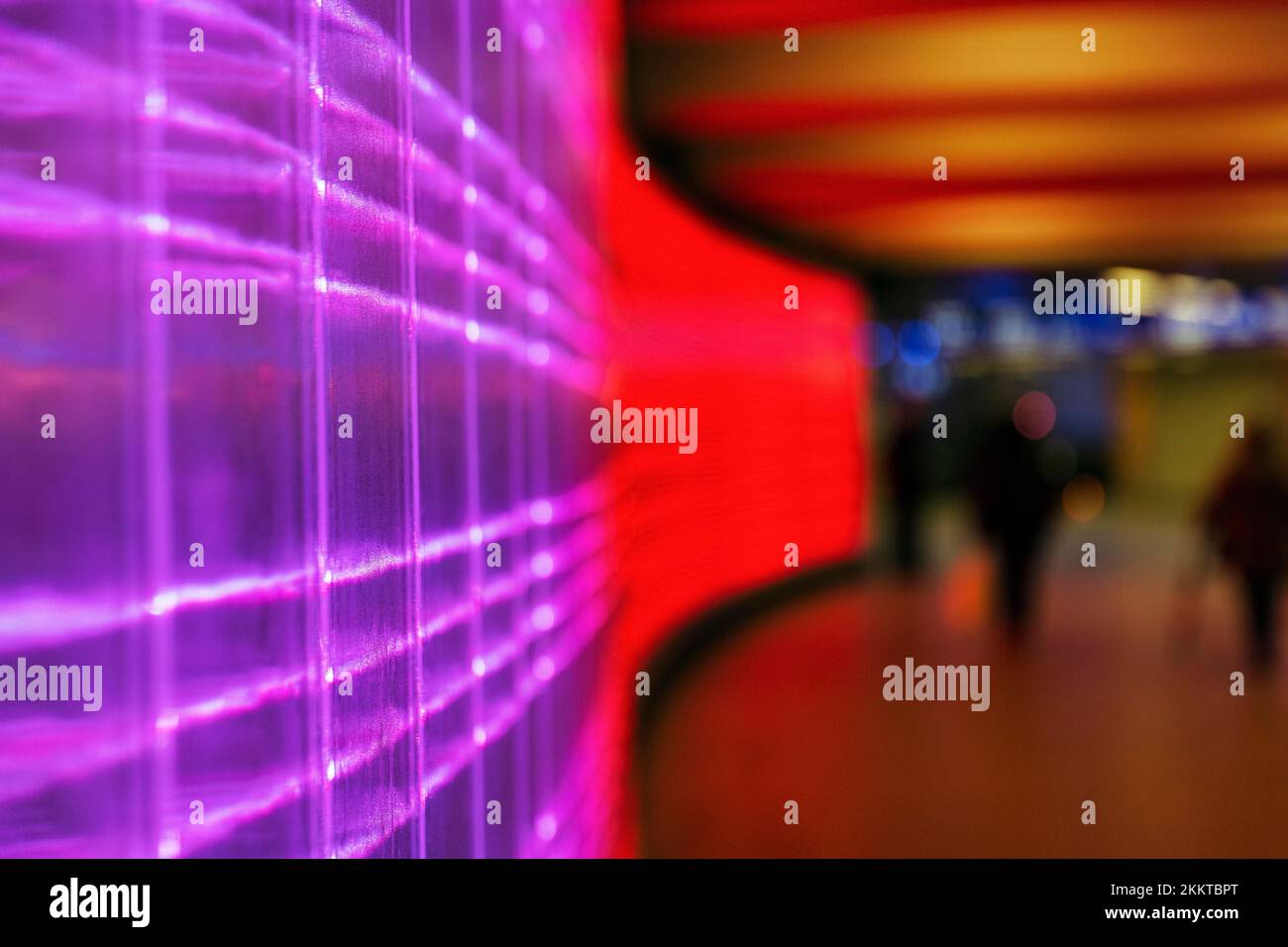 Passers-by in Passerelle underground passage, colourfully illuminated ...