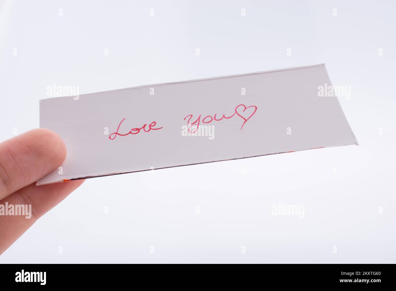 Hand holding a note paper on a white background Stock Photo - Alamy