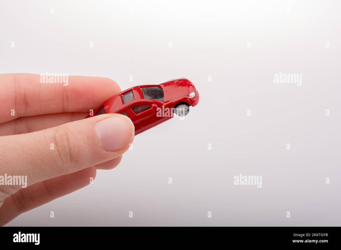 Colorful little toy car in hand on white background Stock Photo - Alamy