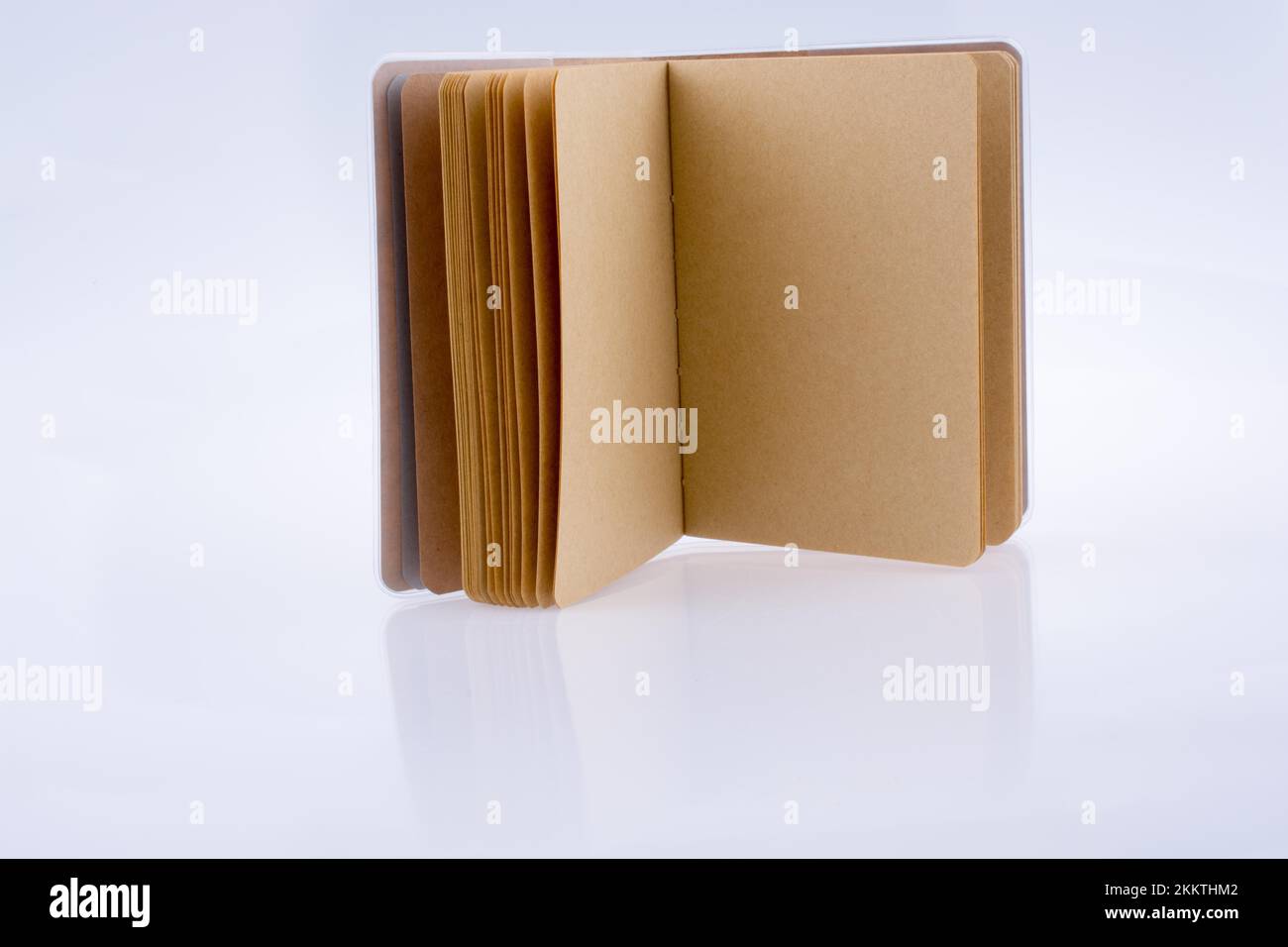 Brown color notebook with open pages on a white background Stock Photo ...