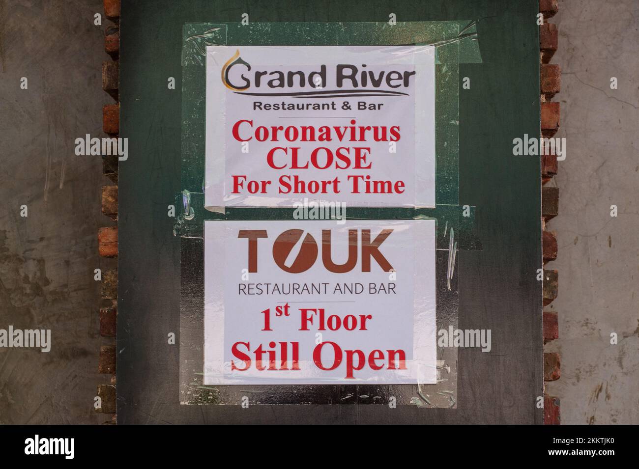 A restaurant on the riverside displays a "Coronavirus CLOSE" sign ...