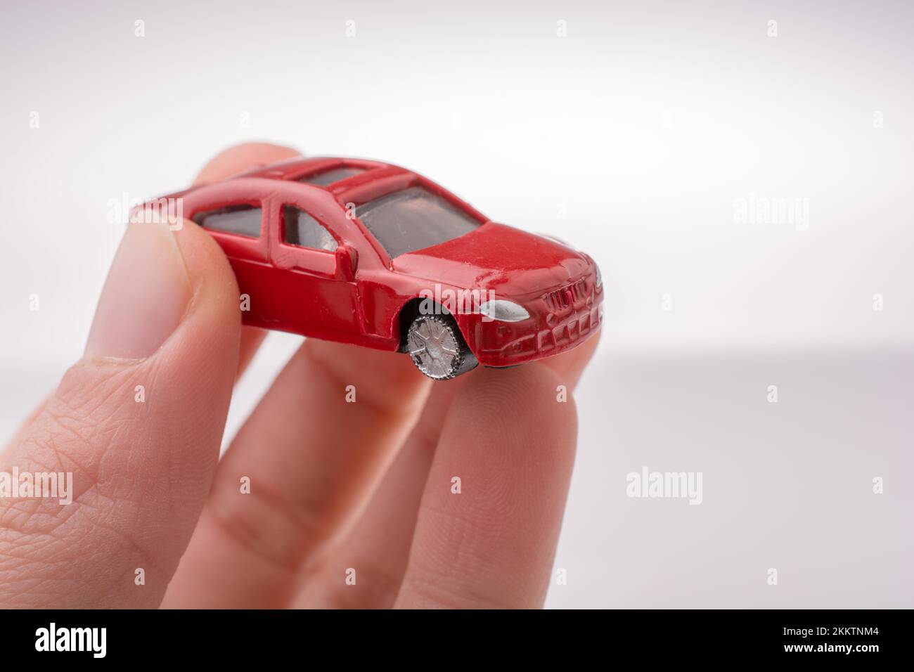 Colorful little toy car in hand on white background Stock Photo - Alamy
