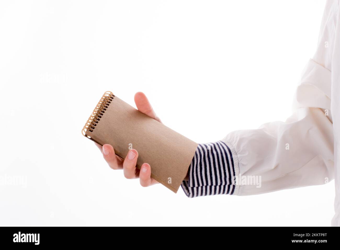 Hand holding a notebook on a white background Stock Photo - Alamy
