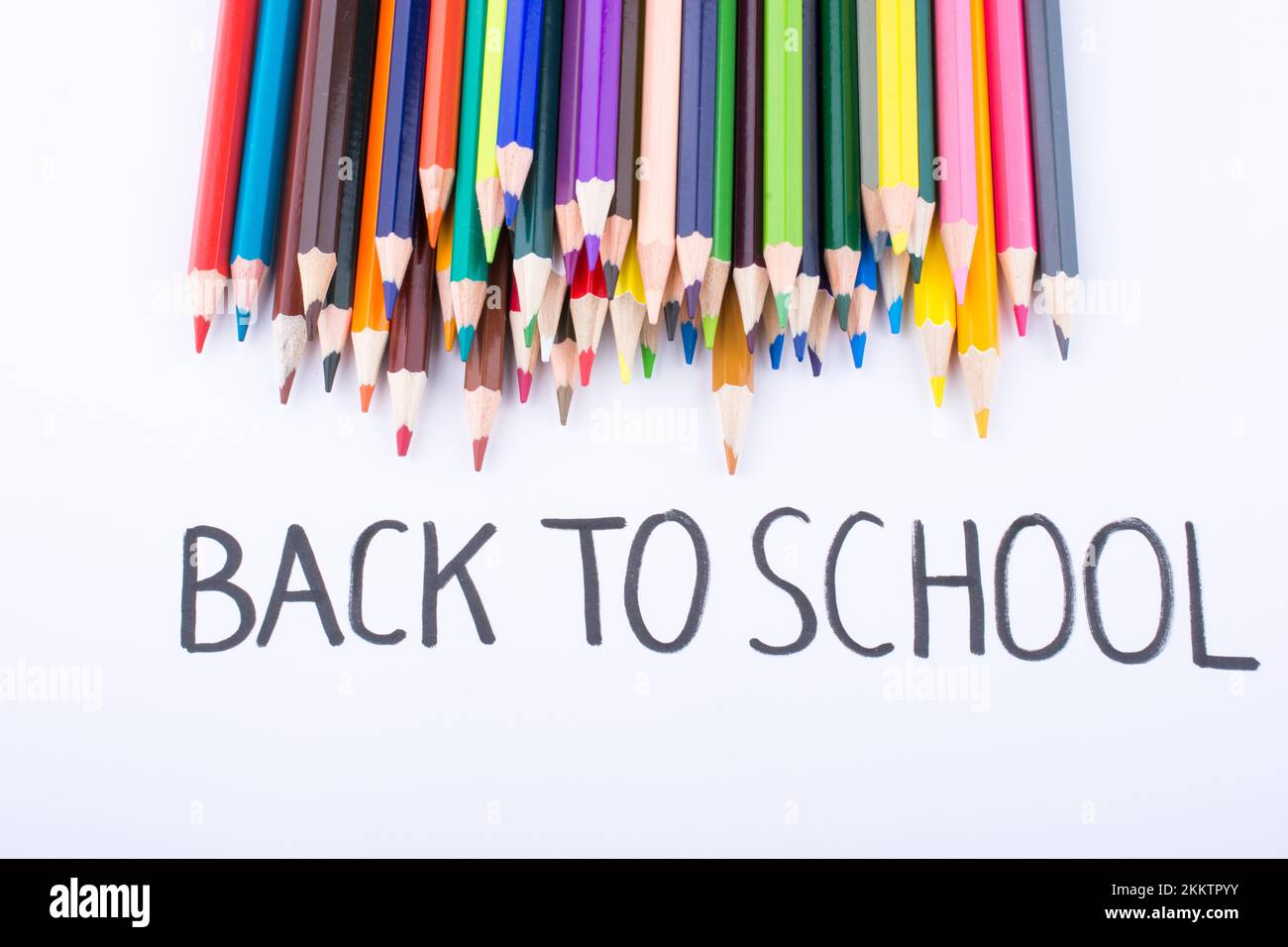 Color pencils and back to school title on a notebook Stock Photo - Alamy
