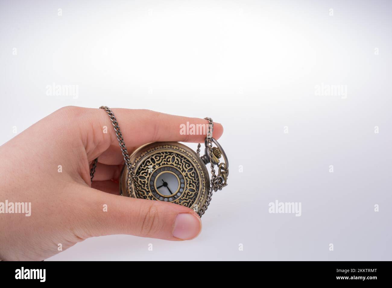 Retro style pocket watch in hand on white background Stock Photo - Alamy
