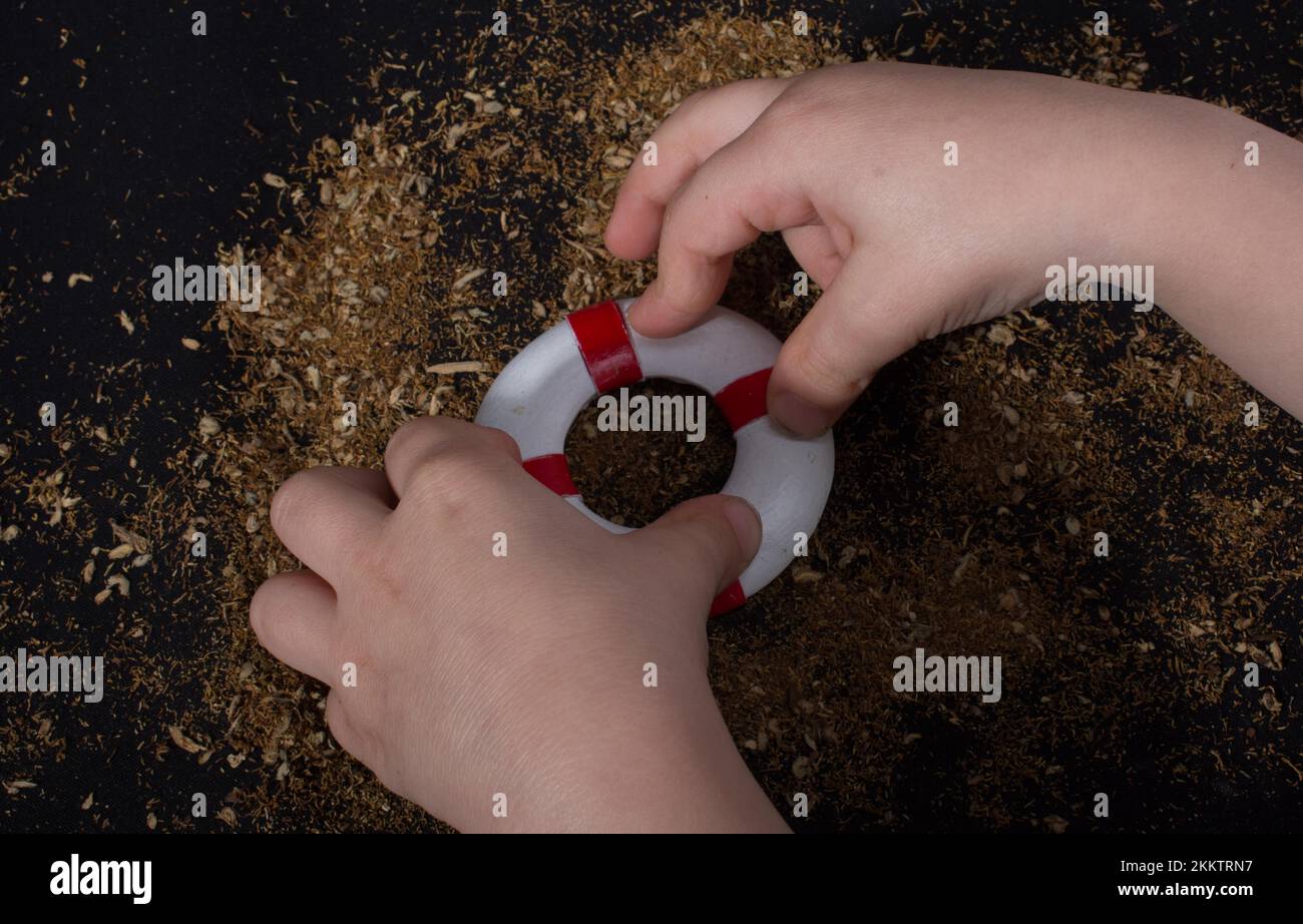 Little model life preserver is being held in hand Stock Photo - Alamy