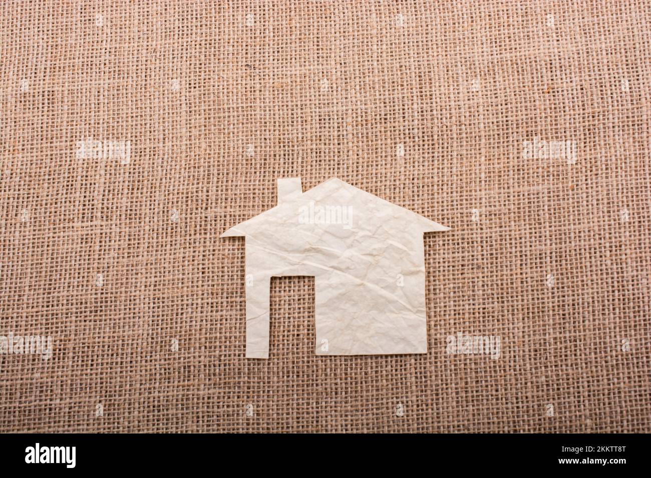 Little house shape cut out of paper on a canvas background Stock Photo ...