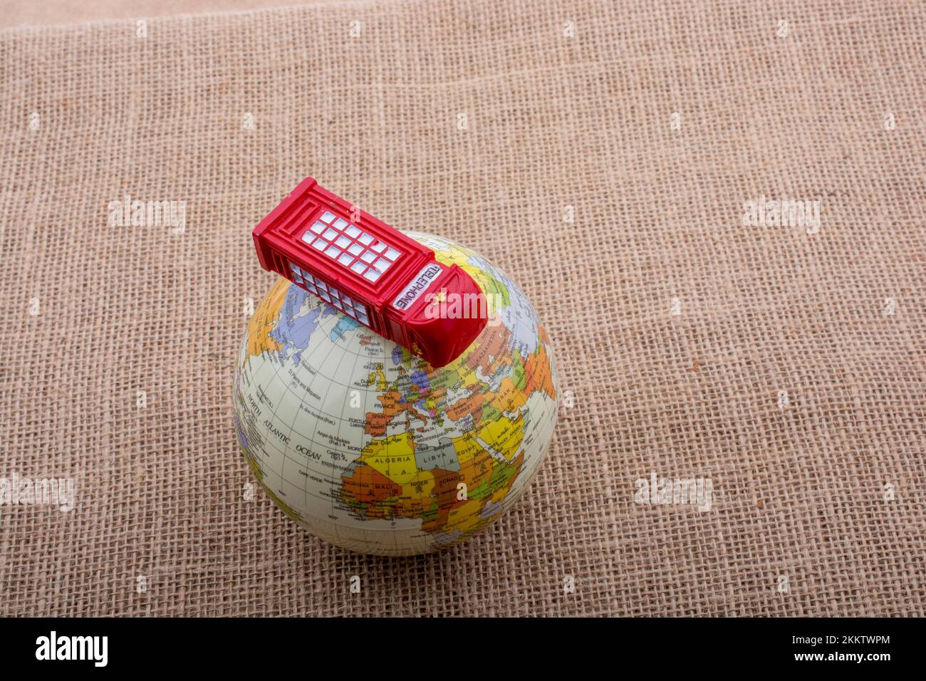 Globe with a telephone booth on canvas background Stock Photo - Alamy
