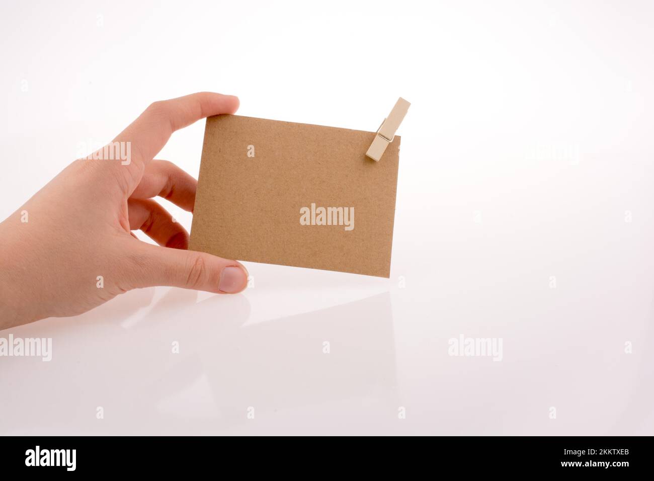 Hand holding a paper with a clip on it Stock Photo - Alamy