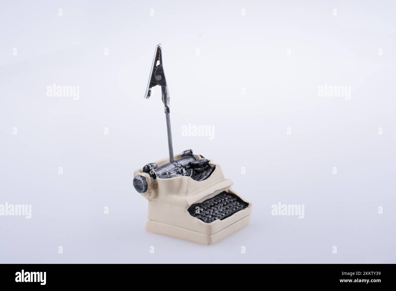 Retro syled tiny typewriter model on a white background Stock Photo - Alamy