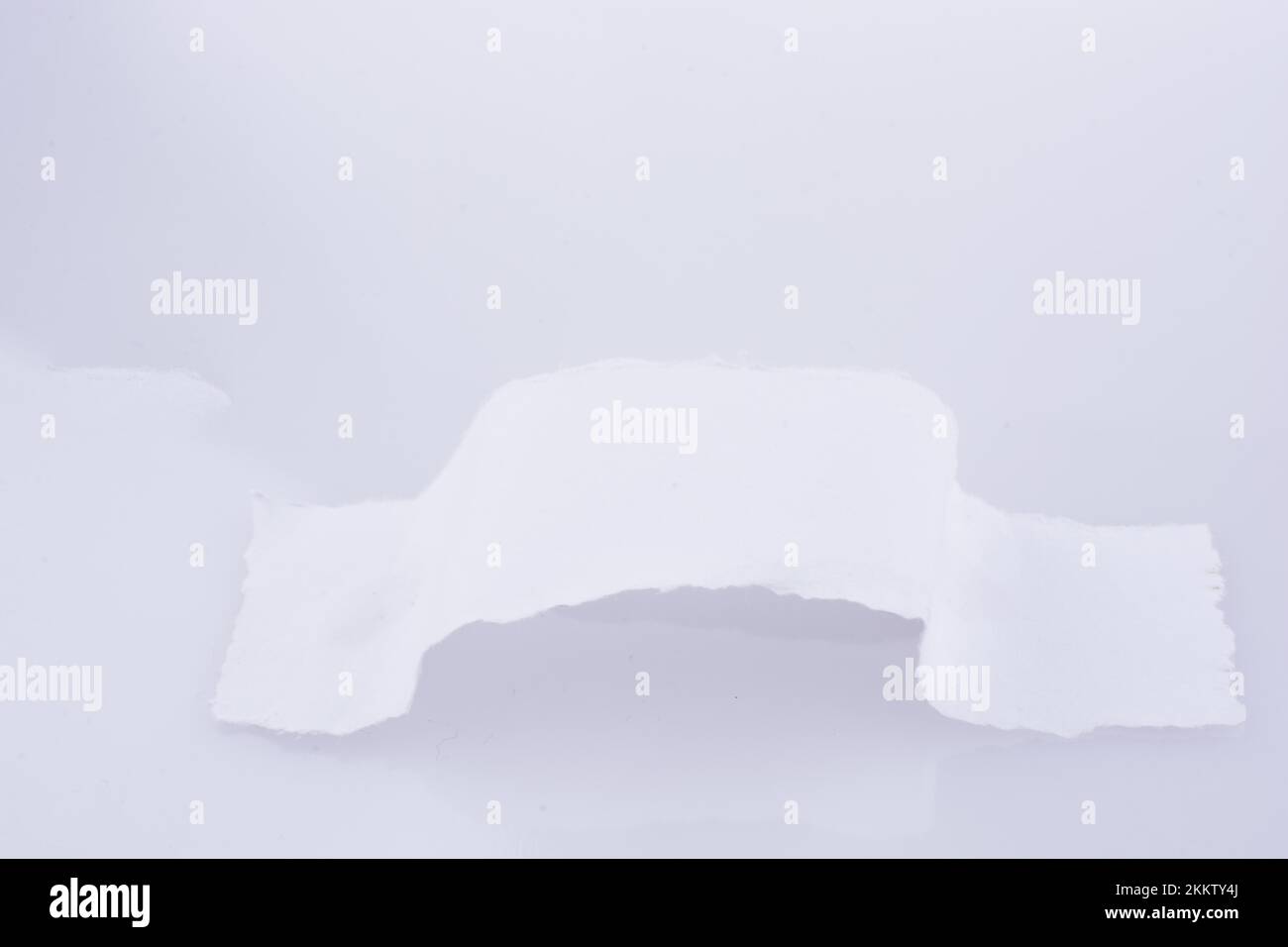 Piece of torn paper on a white background Stock Photo - Alamy