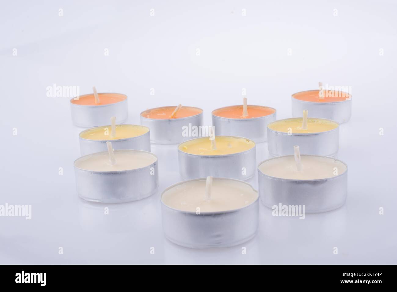 Colorful small Candles on a white background Stock Photo - Alamy