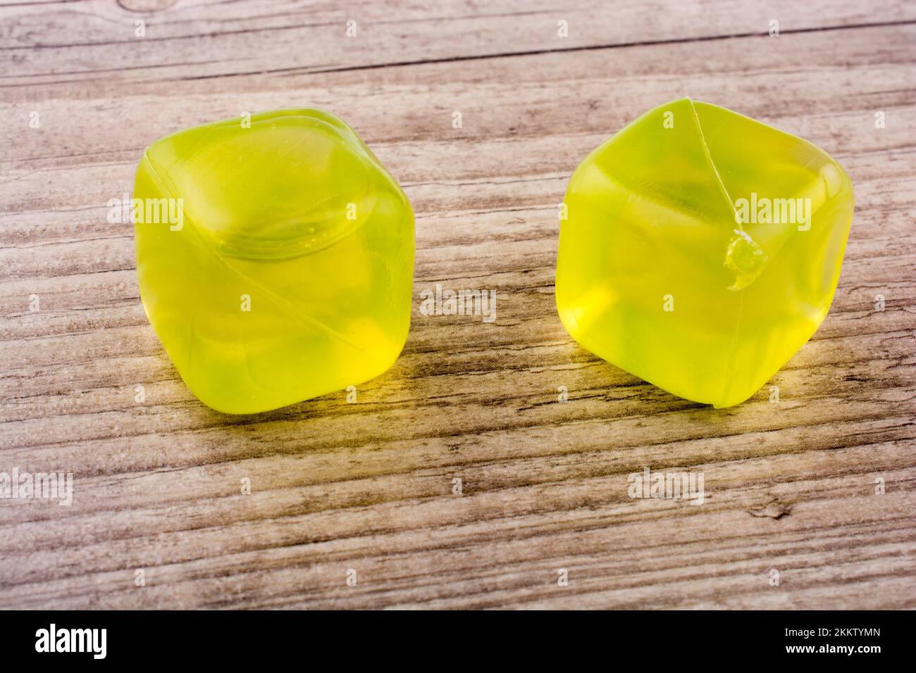 Fake colorful ice cubes in color onwood background Stock Photo - Alamy