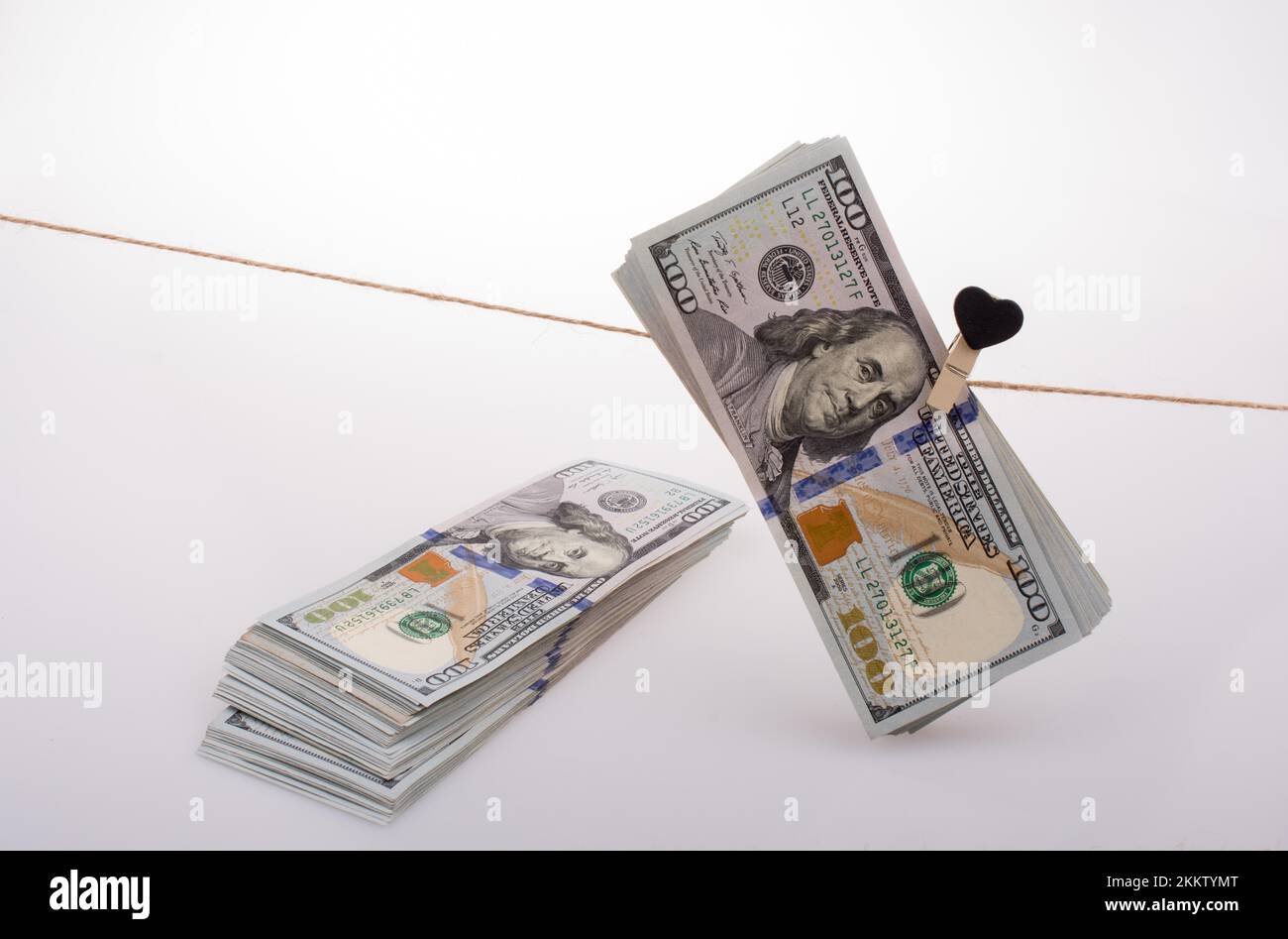 American 100 dollar banknotes with a heart clip on a string Stock Photo ...