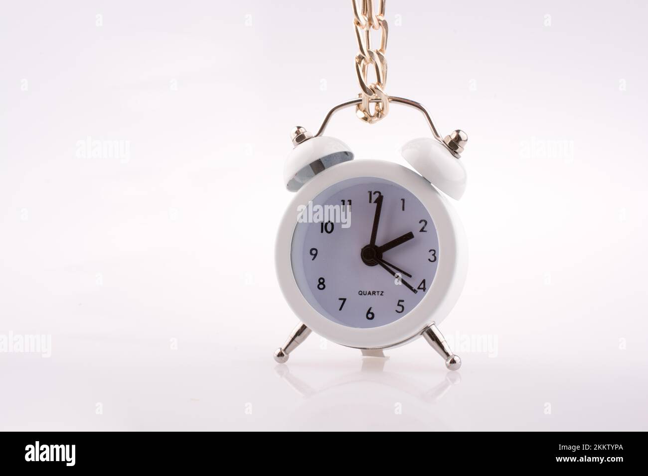 White color alarm clock on white background Stock Photo - Alamy