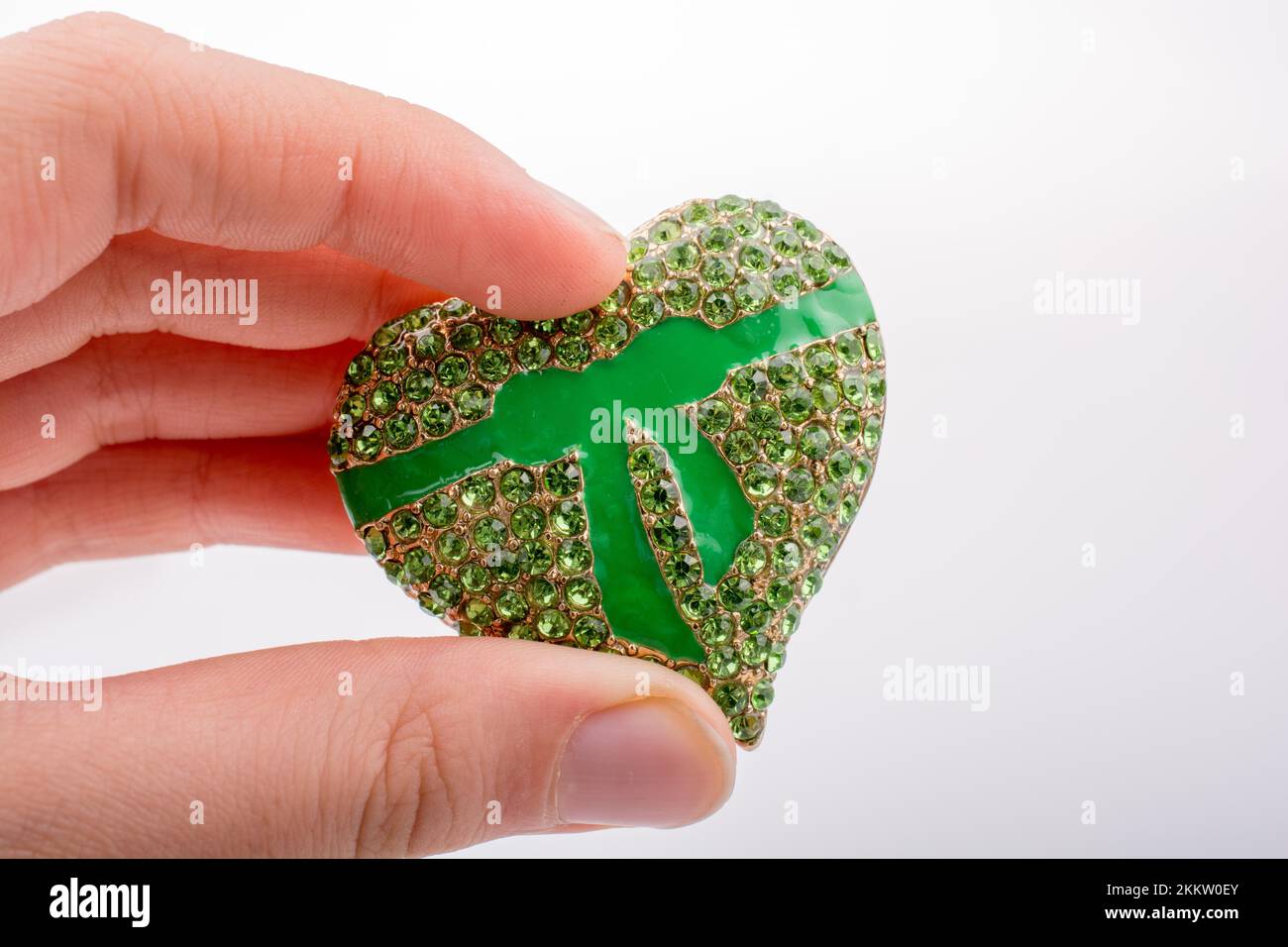 Heart shaped object in hand on a white background Stock Photo - Alamy