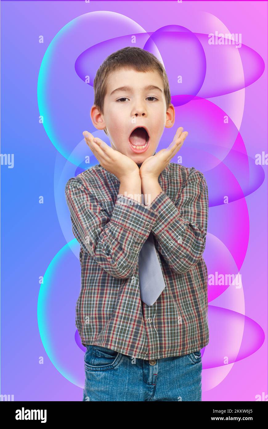 Scared and surprised six years old boy holding hands up to face and ...