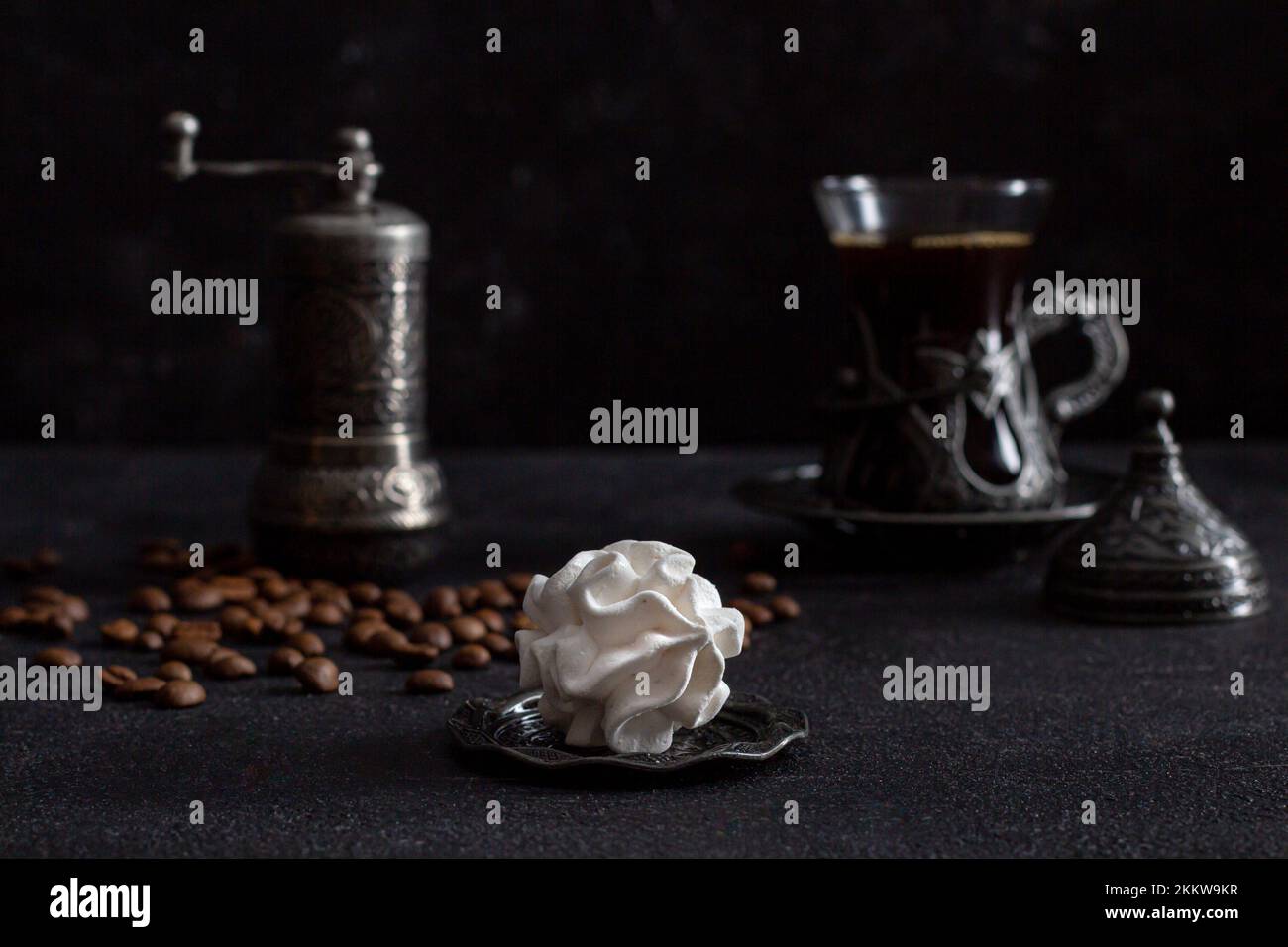 zepfyr on a dark background in a plate in the background - a cup of ...