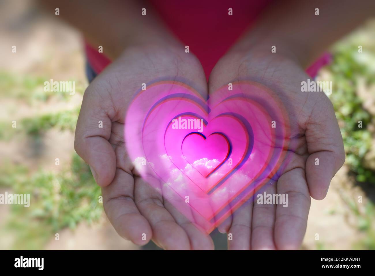 both palms open upwards with a symbol of love on it. as a symbol of the ...