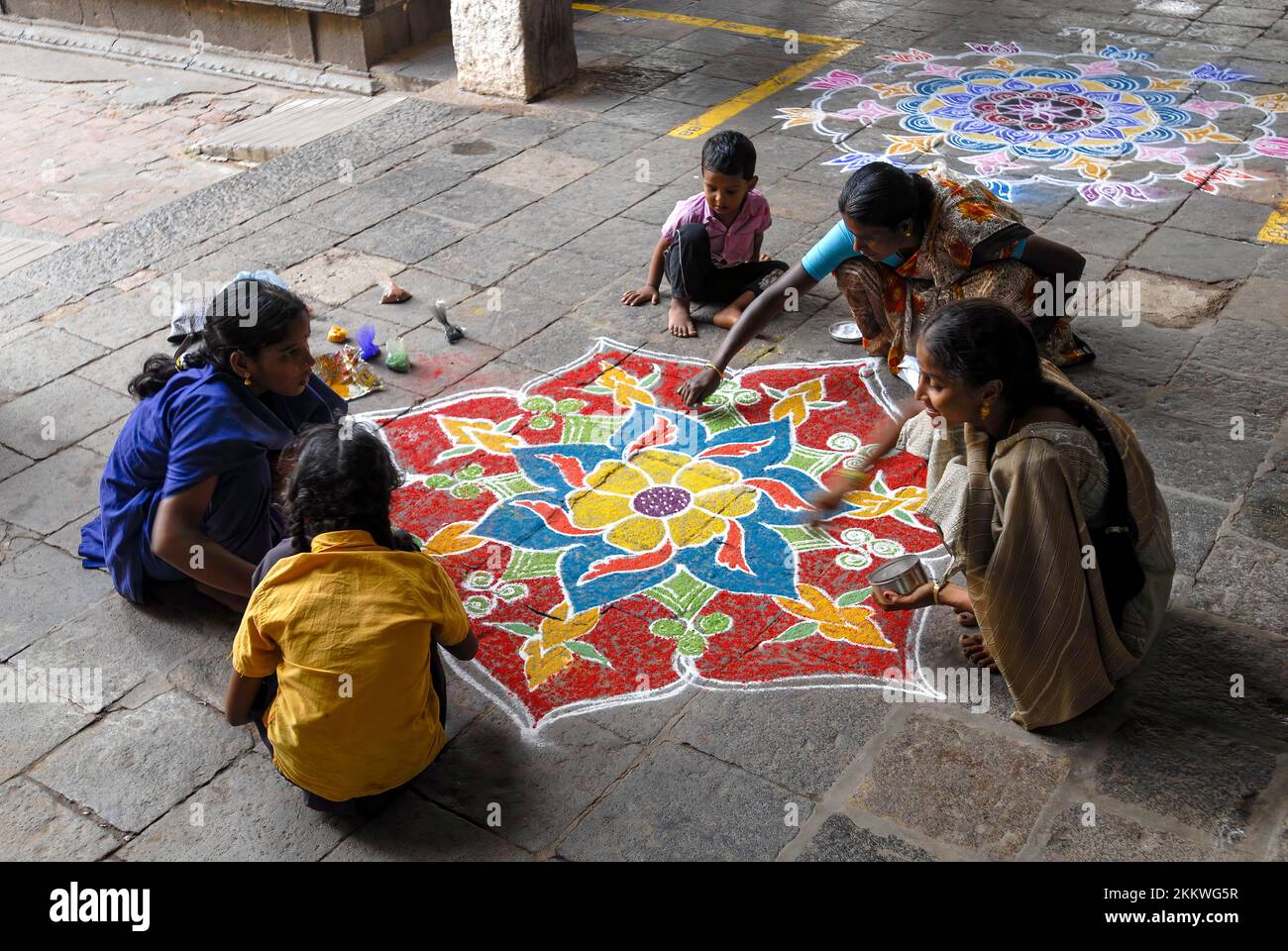 Drawing kolam, rangoli inside the temple floor, Sri Neelayadhakshi ...