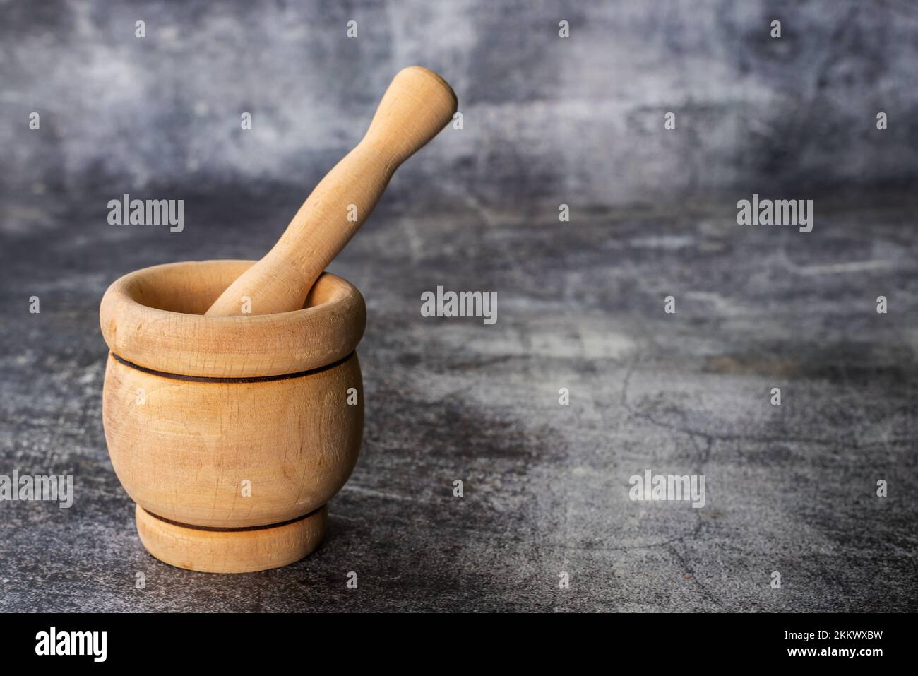 Wooden mortar,kitchen utensil for mash,on a gray stone background Stock ...