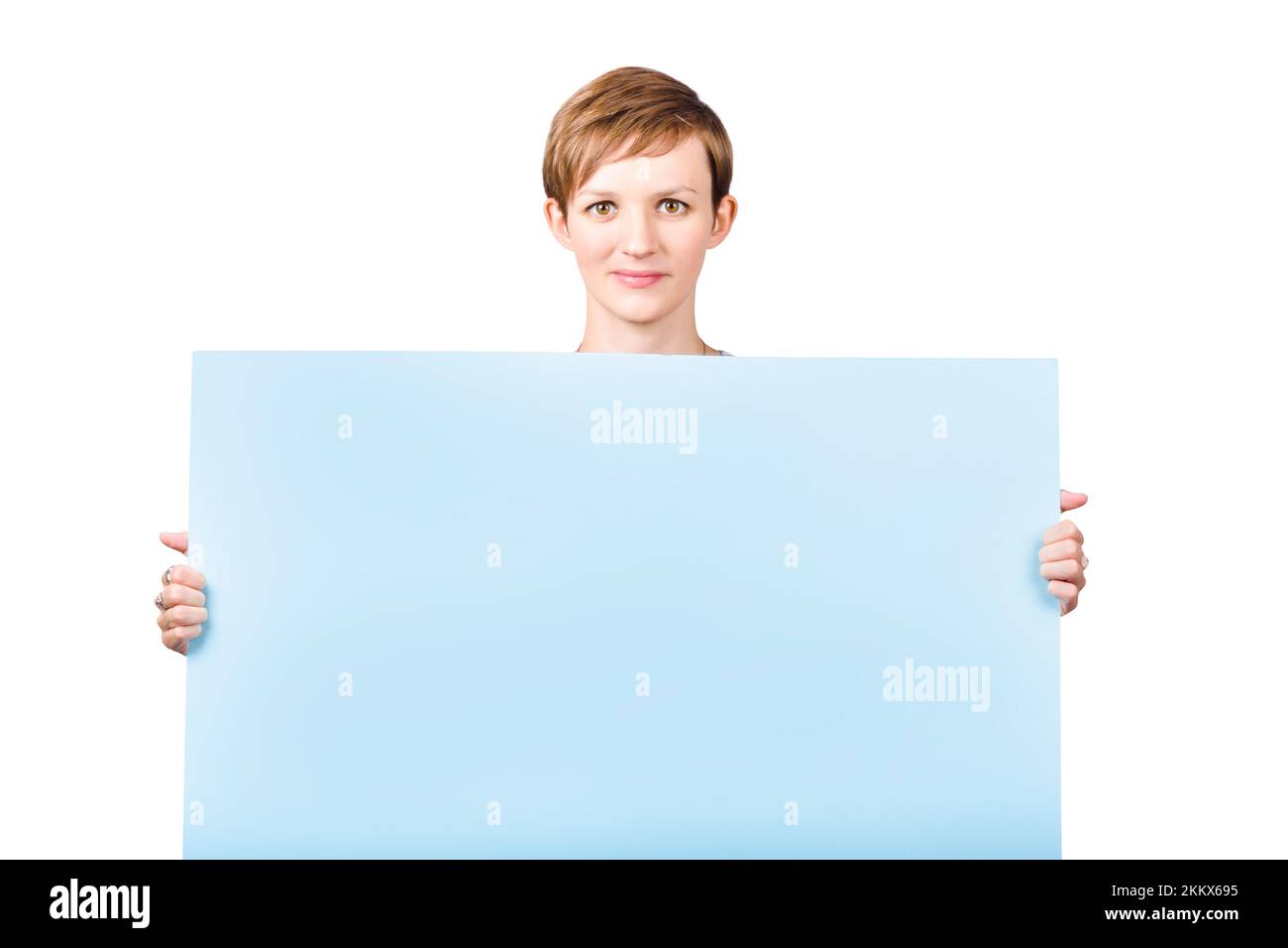 Pretty pert young woman with a lovely warm smile holding a rectangular ...