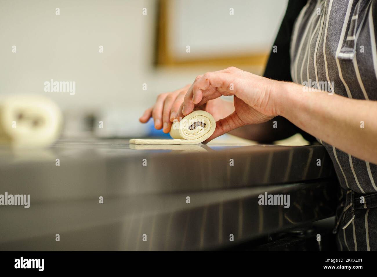A closeup of hands making dessert in a bakery Stock Photo - Alamy