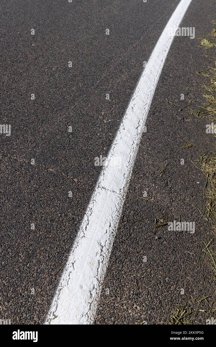 Paved highway with white road markings, traffic regulation using lines ...