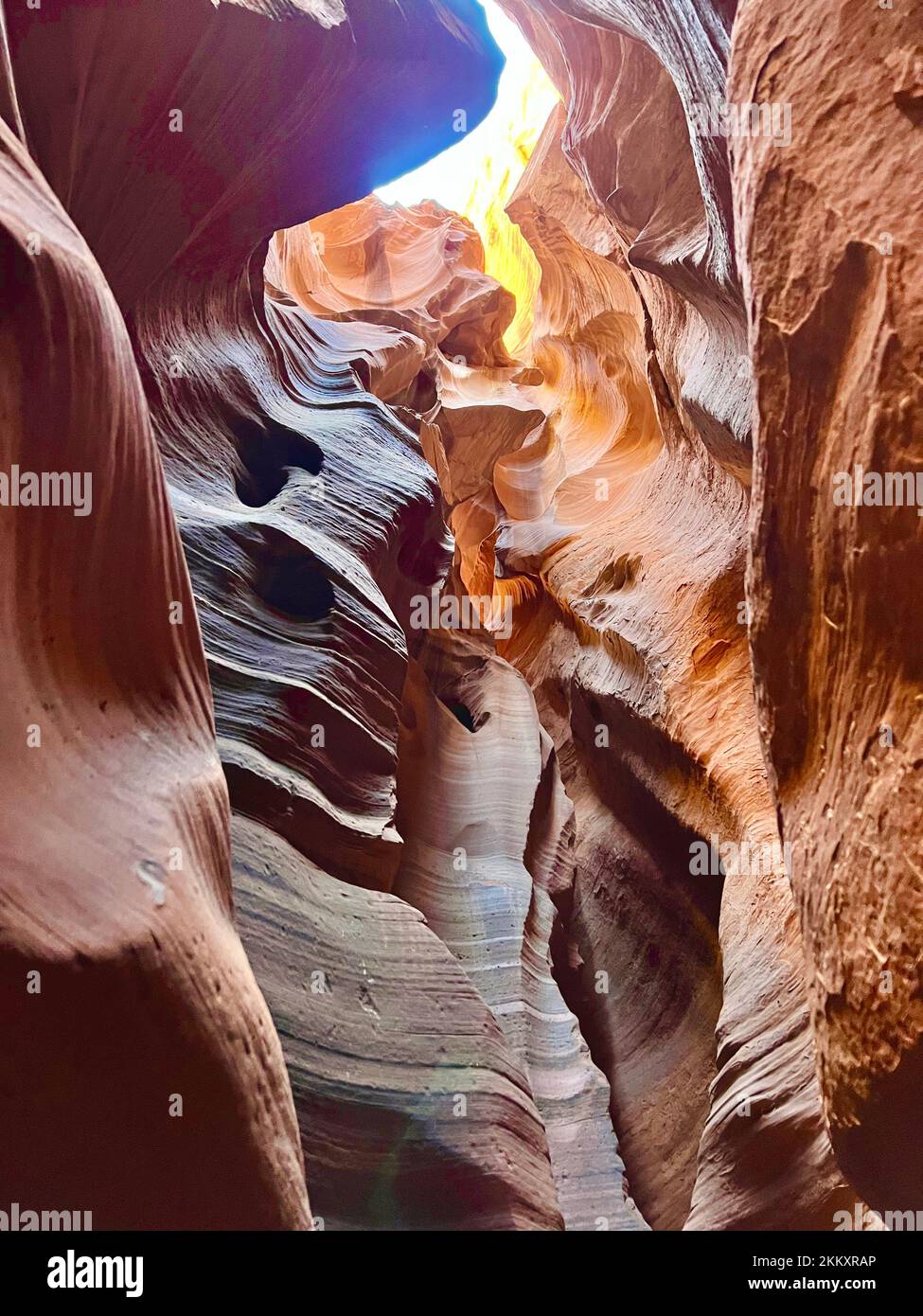 An inside view of a cave in Canyon X with red eroded sand rocks under ...