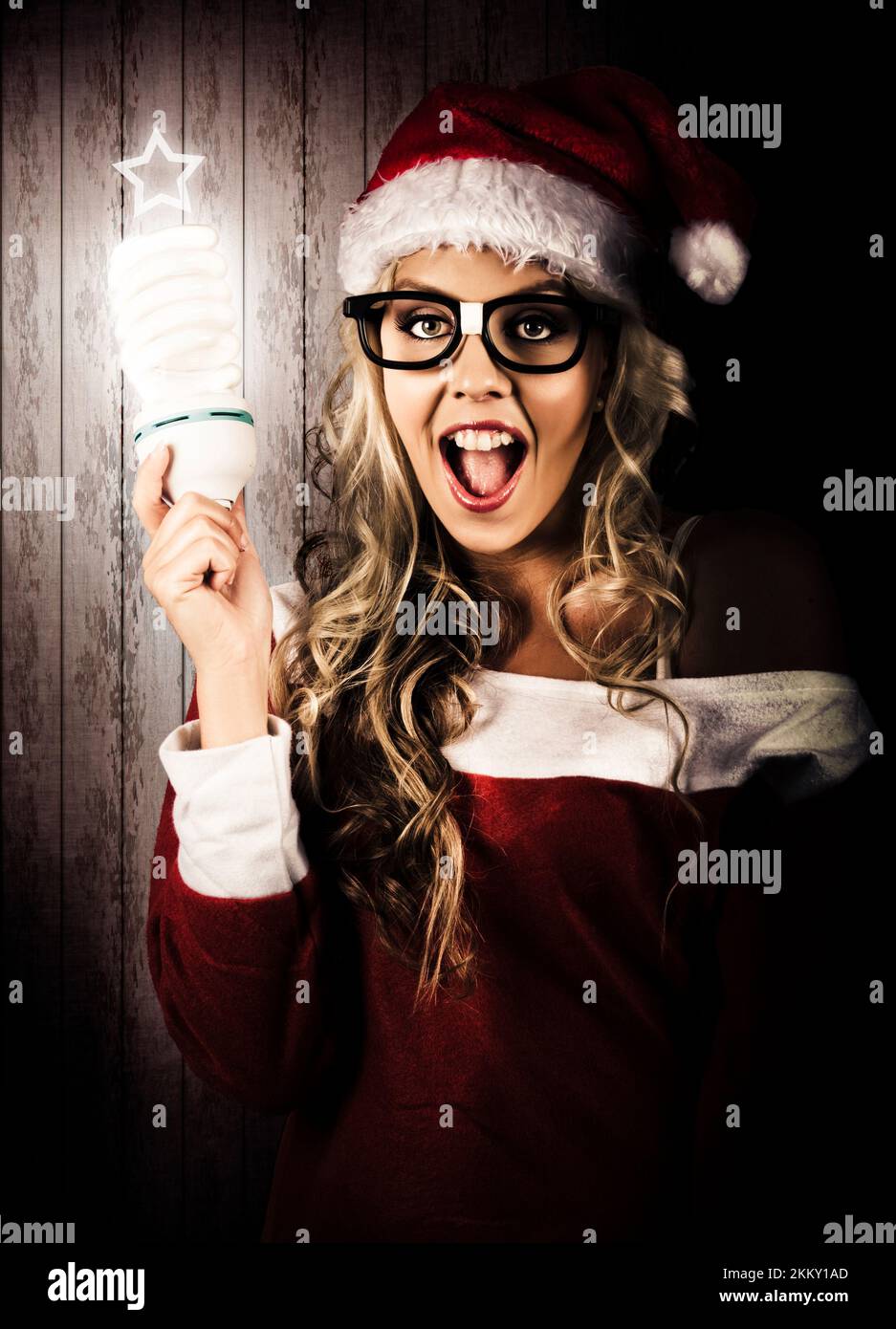 Smart Female Santa Claus Holding Fluorescent Xmas Tree Light Bulb With ...
